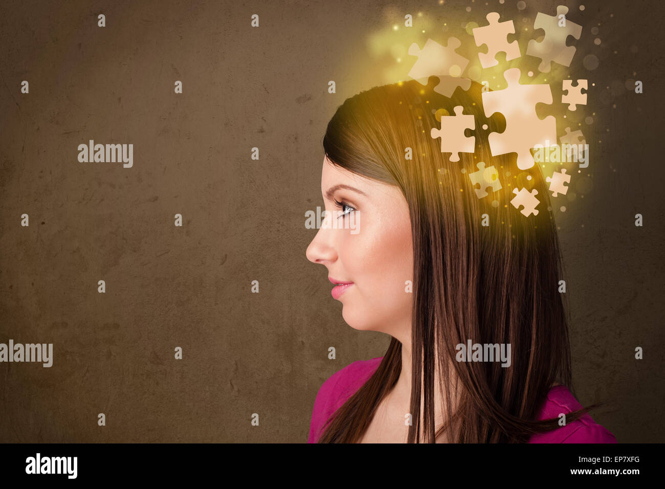 Young person thinking with glowing puzzle mind Stock Photo - Alamy