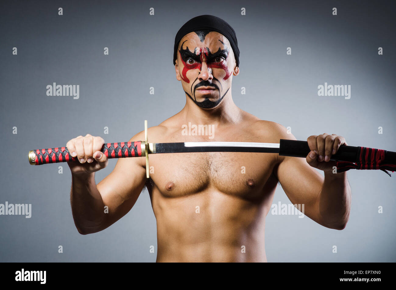 Man with sword and face paint Stock Photo - Alamy