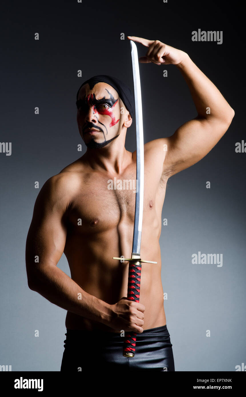 Man with sword and face paint Stock Photo - Alamy