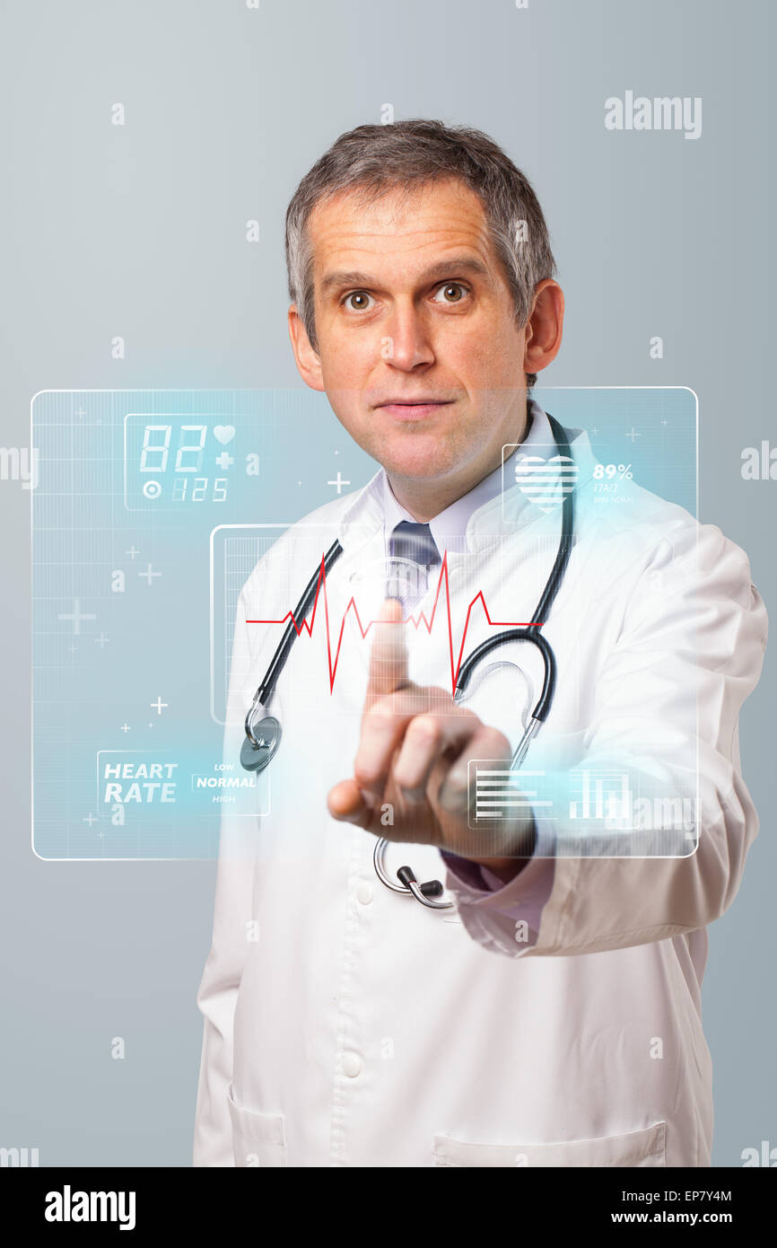 Middle aged doctor pressing modern medical type of button Stock Photo ...
