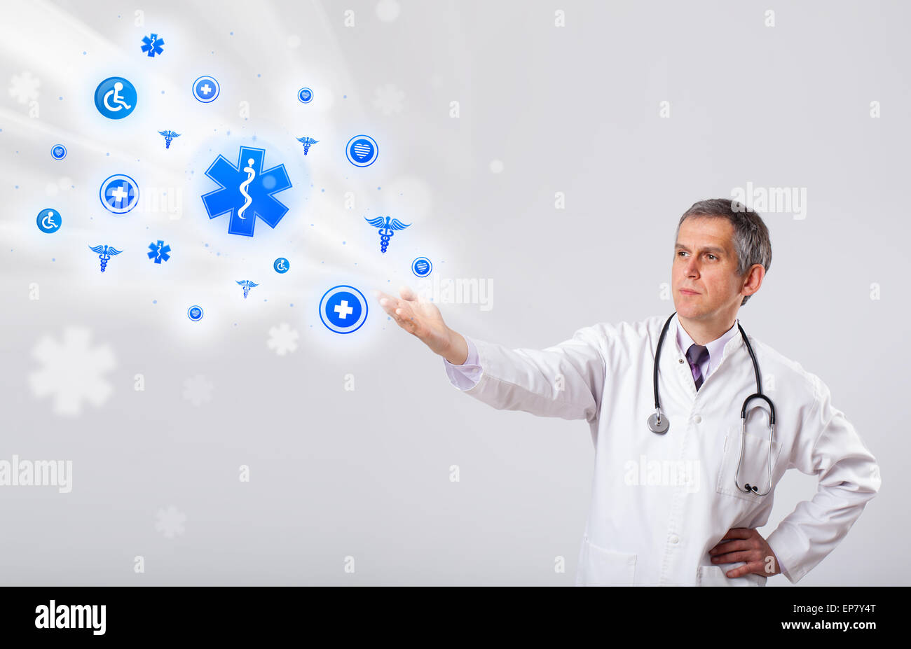 Doctor with blue medical icons Stock Photo - Alamy