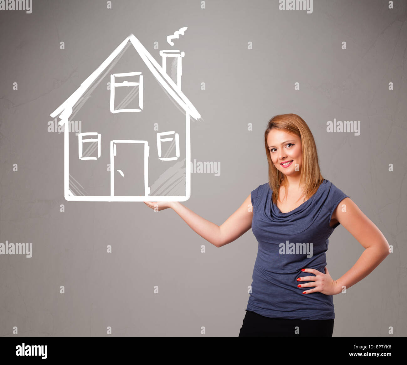 Young lady holding a huge drawn house Stock Photo - Alamy