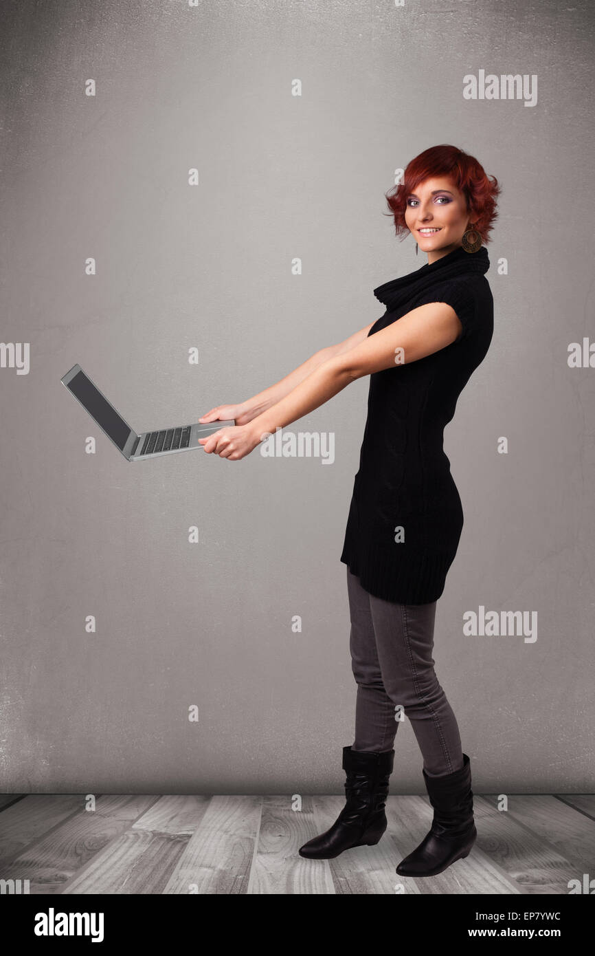 Young woman holding modern laptot Stock Photo - Alamy