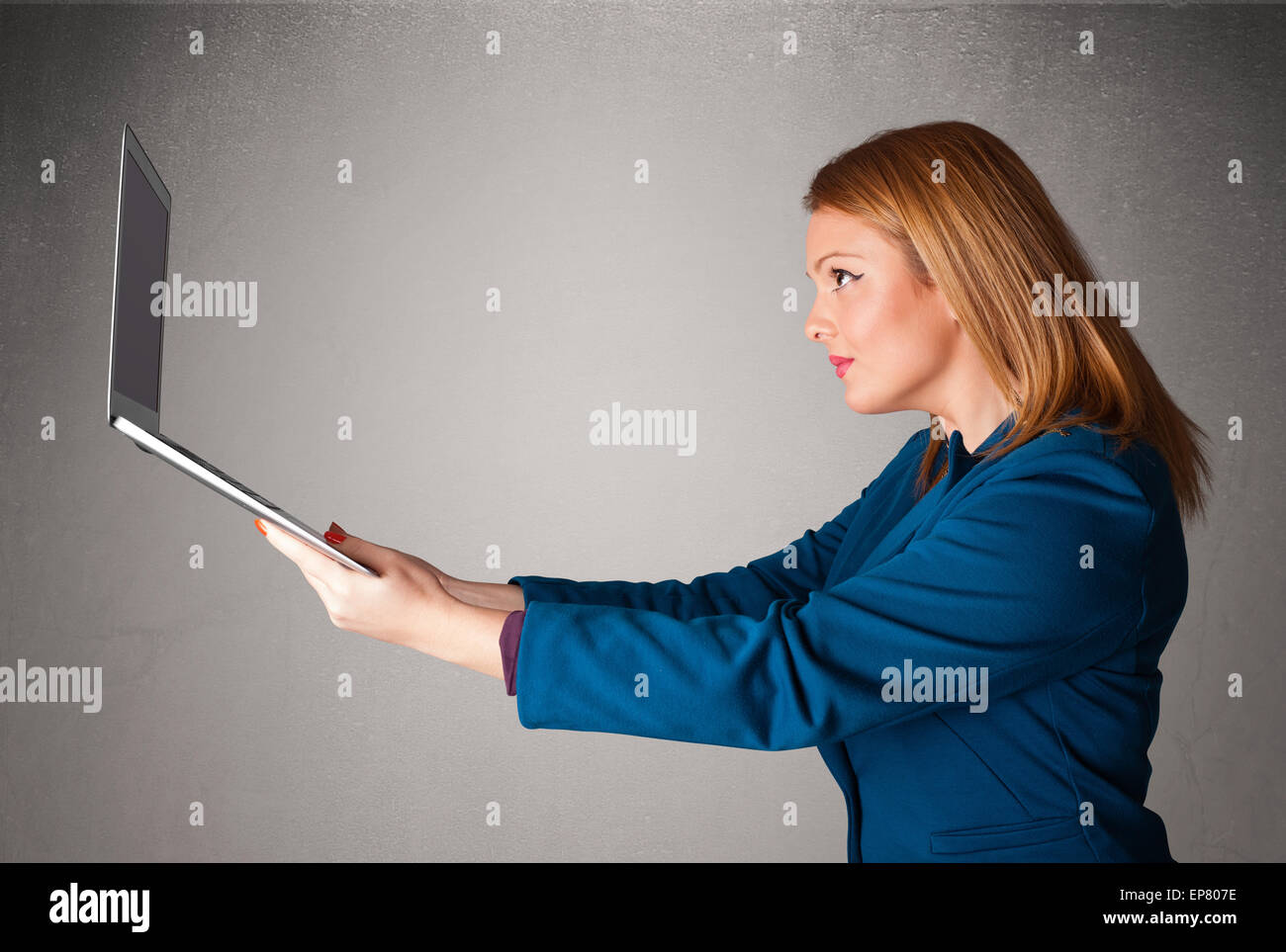 Young woman holding modern laptot Stock Photo - Alamy