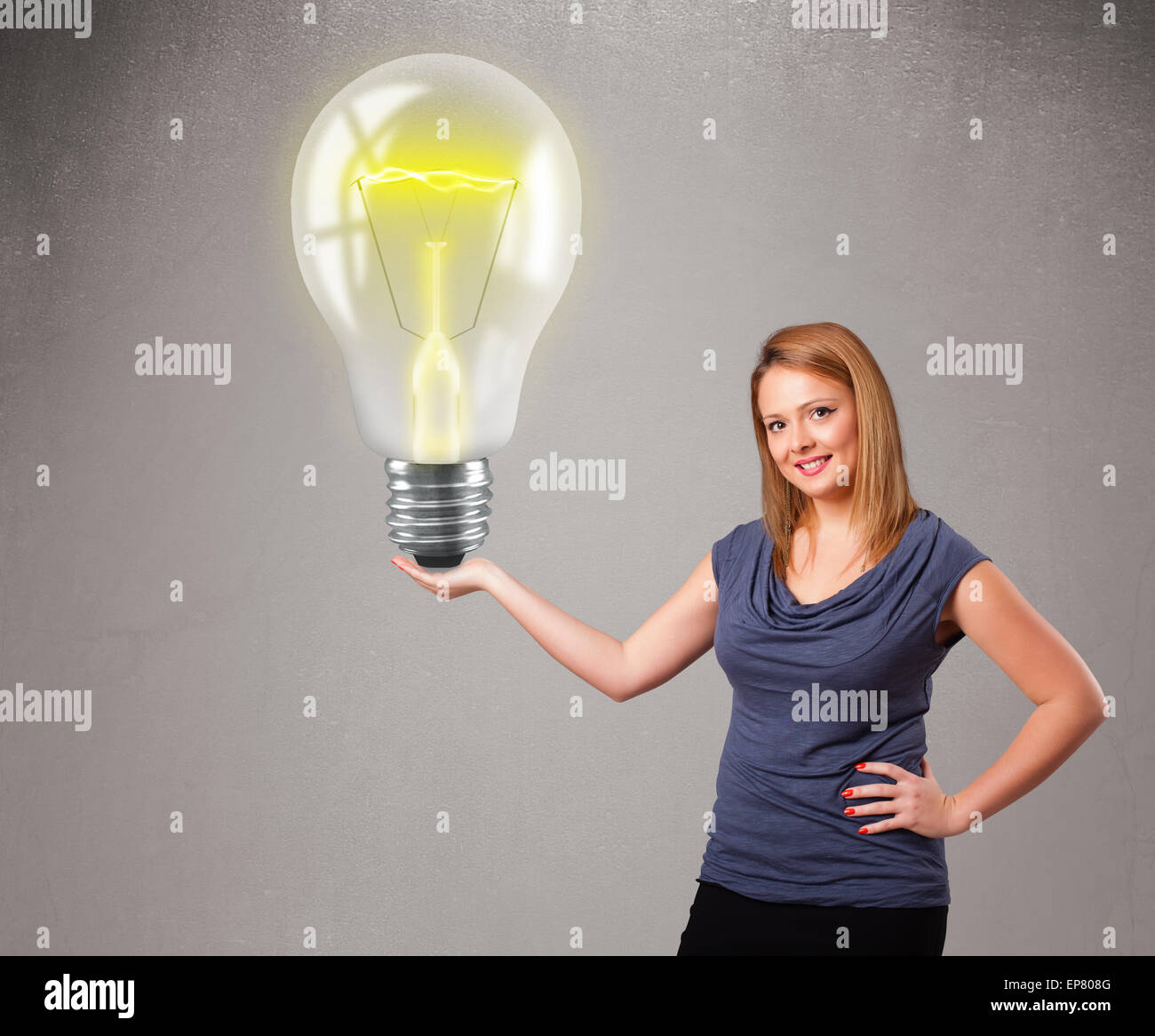 Beautiful lady holding realistic 3d light bulb Stock Photo - Alamy