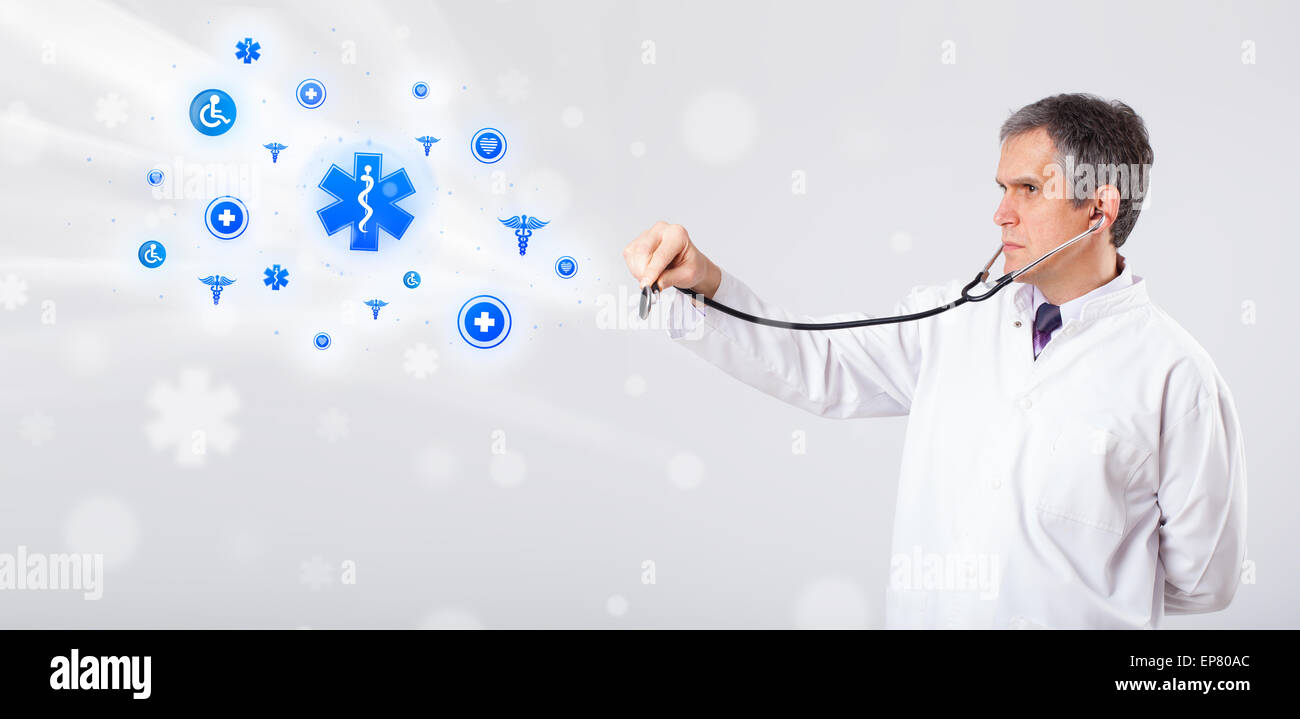 Doctor with blue medical icons Stock Photo - Alamy