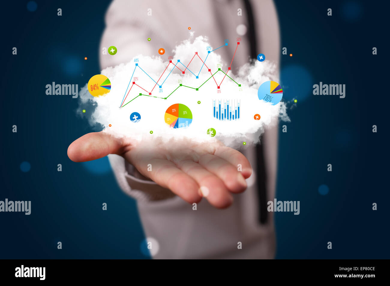 Young businessman presenting cloud with charts and graph icons and ...