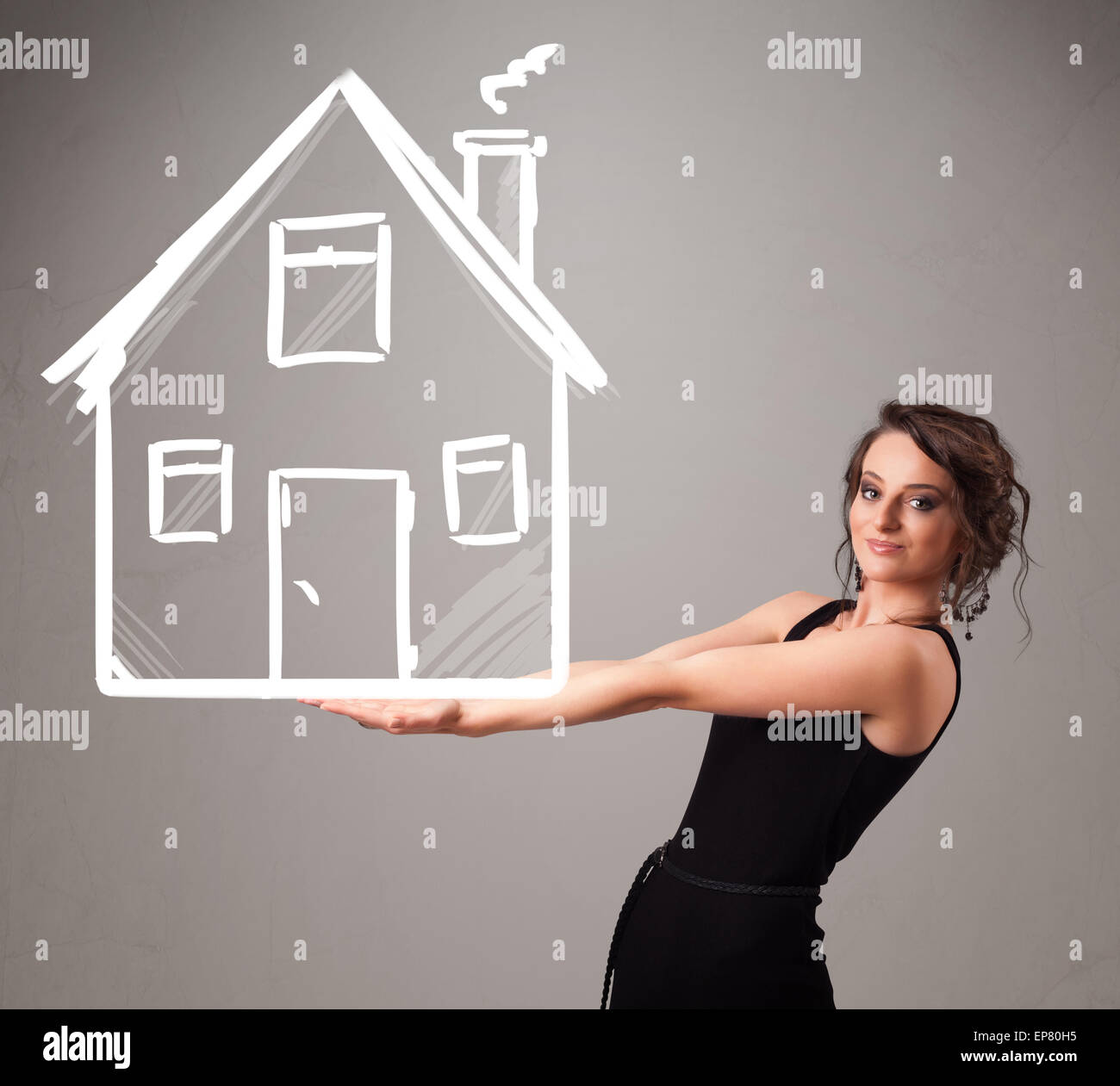 Young lady holding a huge drawn house Stock Photo - Alamy
