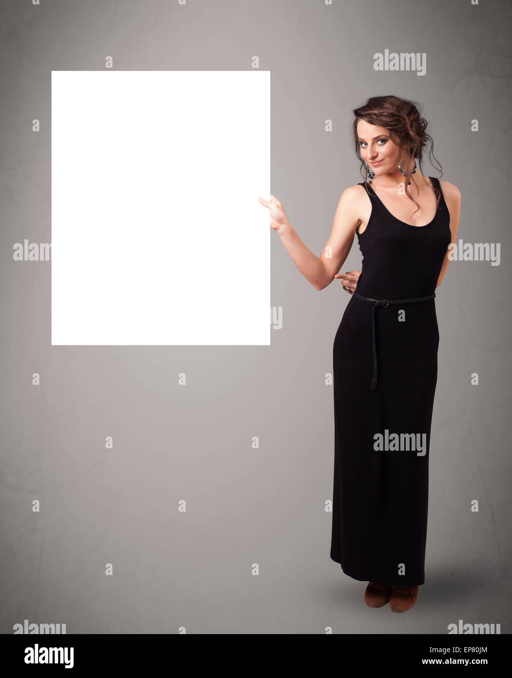 Young woman presenting white paper copy space Stock Photo - Alamy