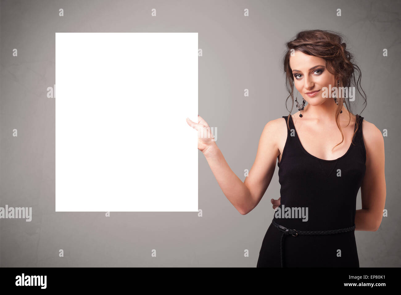 Young woman presenting white paper copy space Stock Photo - Alamy