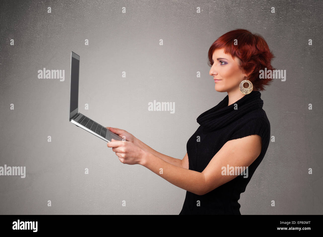 Young woman holding modern laptot Stock Photo - Alamy