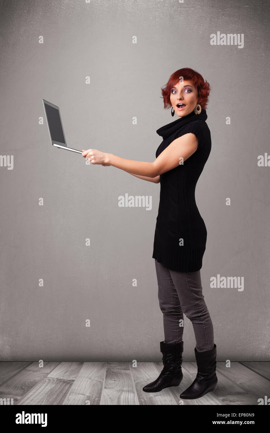 Young woman holding modern laptot Stock Photo - Alamy