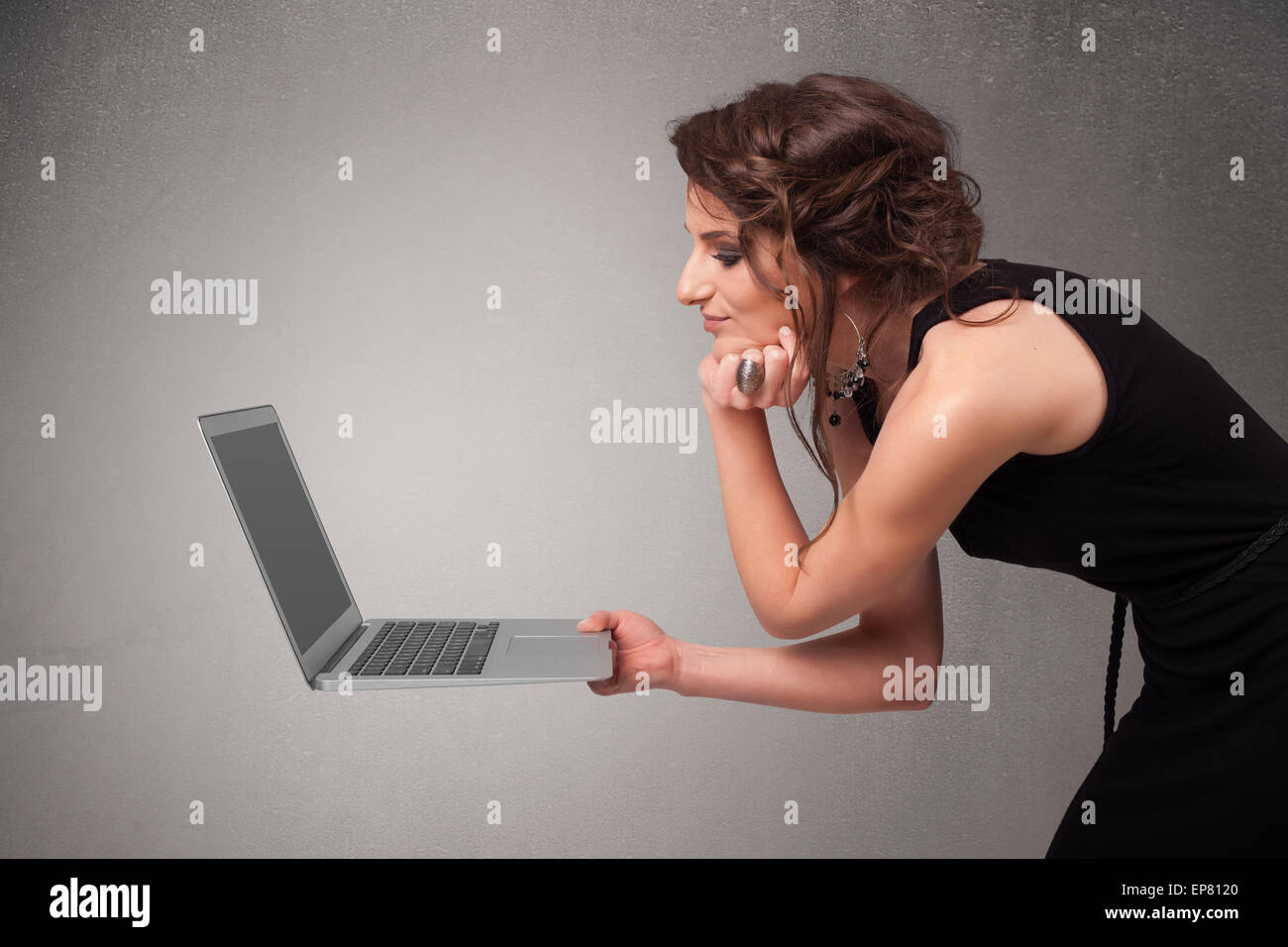Young woman holding modern laptot Stock Photo - Alamy
