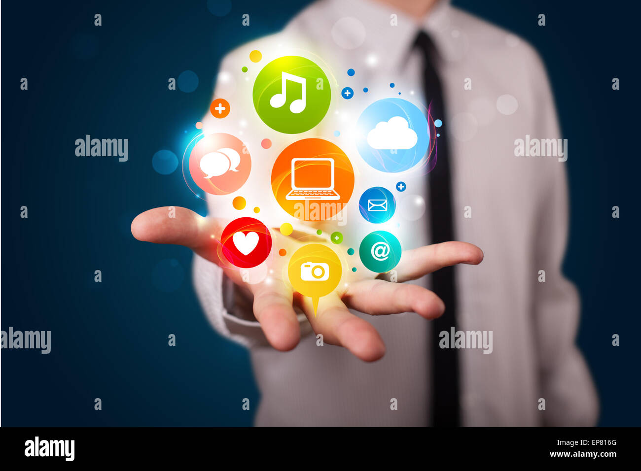 Young businessman presenting colorful technology icons and symbols ...