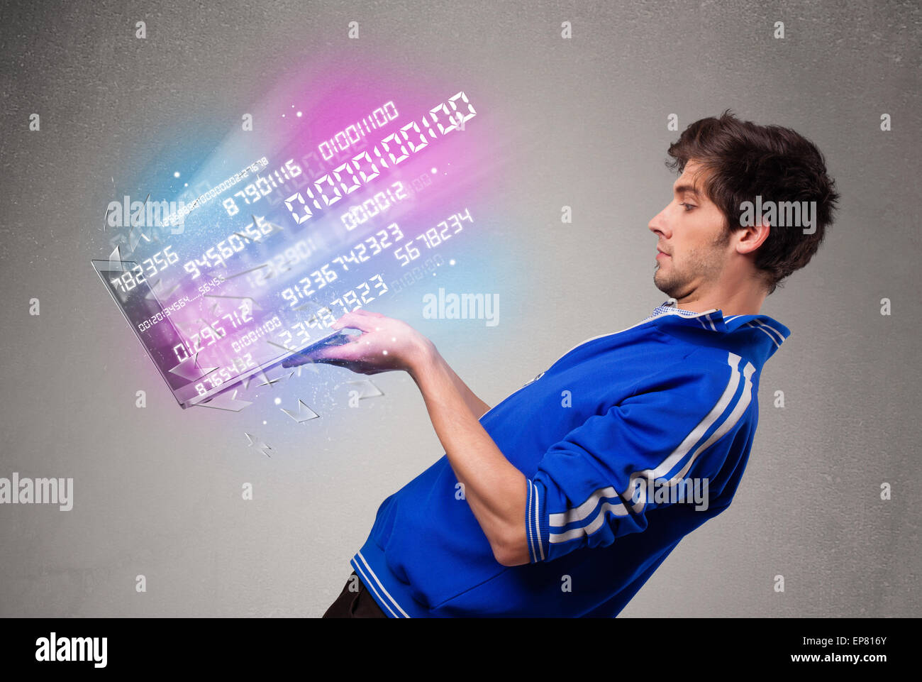 Casual man holding laptop with exploding data and numbers Stock Photo ...