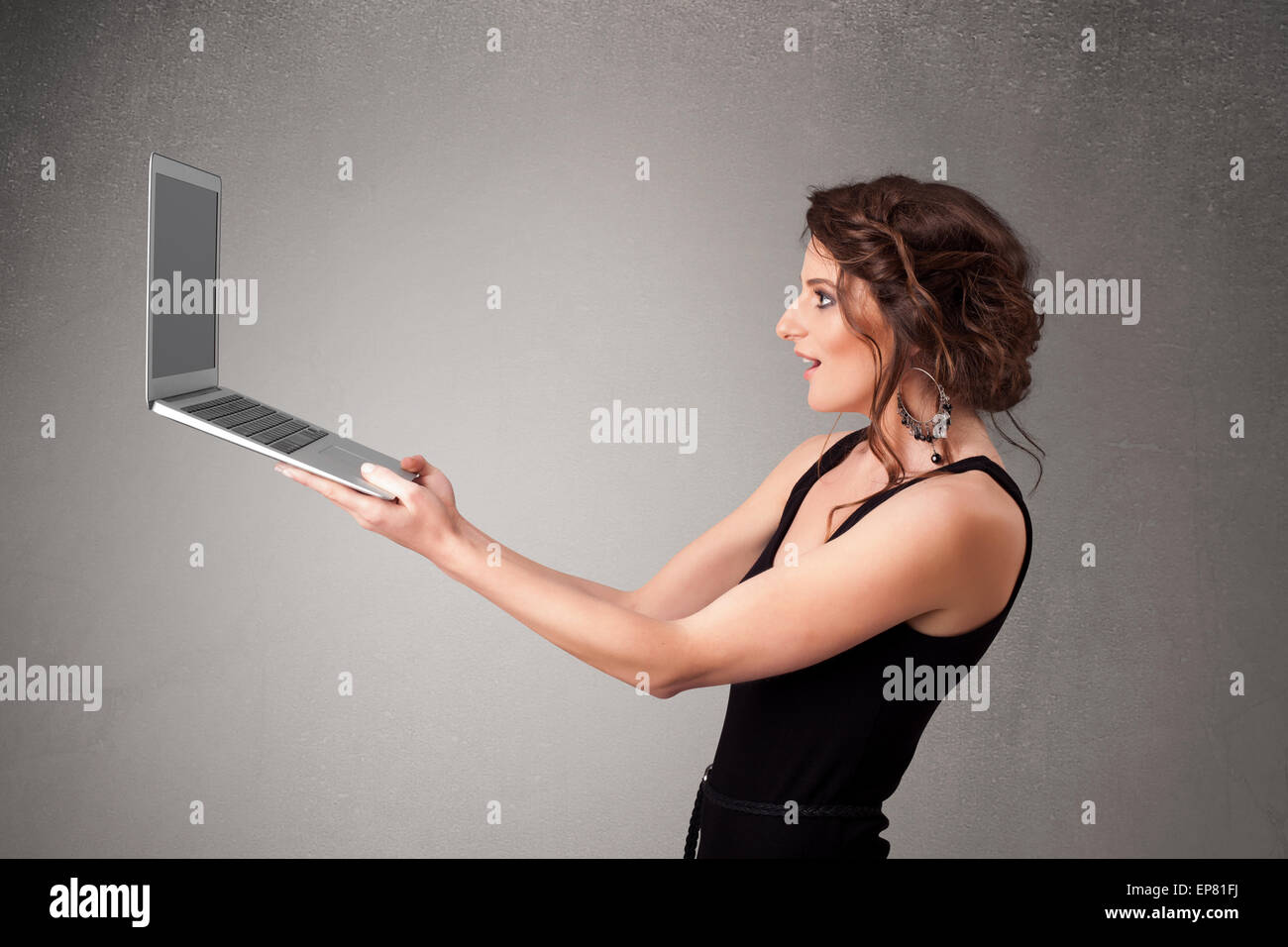Young woman holding modern laptot Stock Photo - Alamy