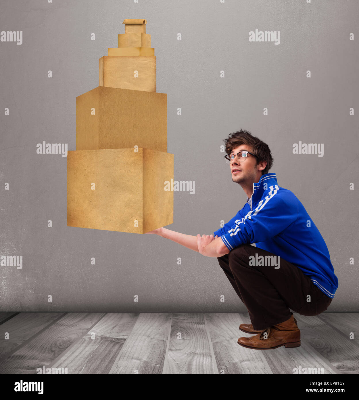 Young man holding a set of brown cardboard boxes Stock Photo - Alamy