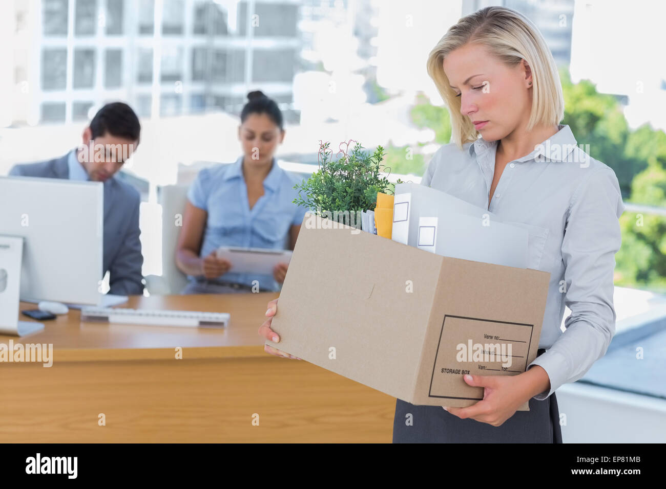 Sad businesswoman leaving office after being let go Stock Photo - Alamy