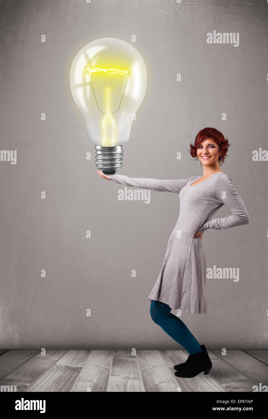 Beautiful lady holding realistic 3d light bulb Stock Photo - Alamy