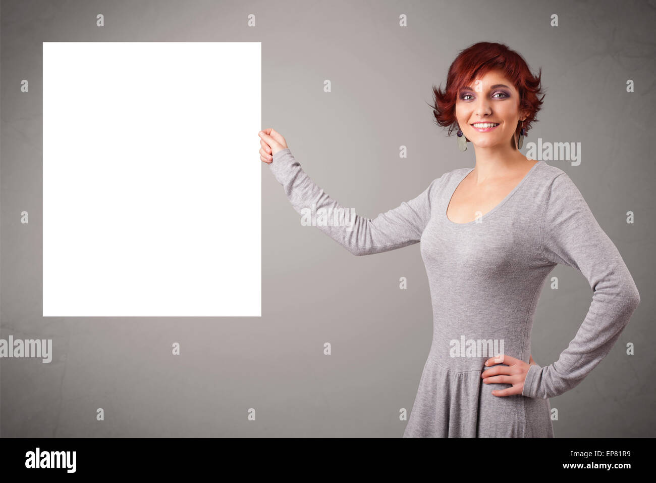Young woman presenting white paper copy space Stock Photo - Alamy