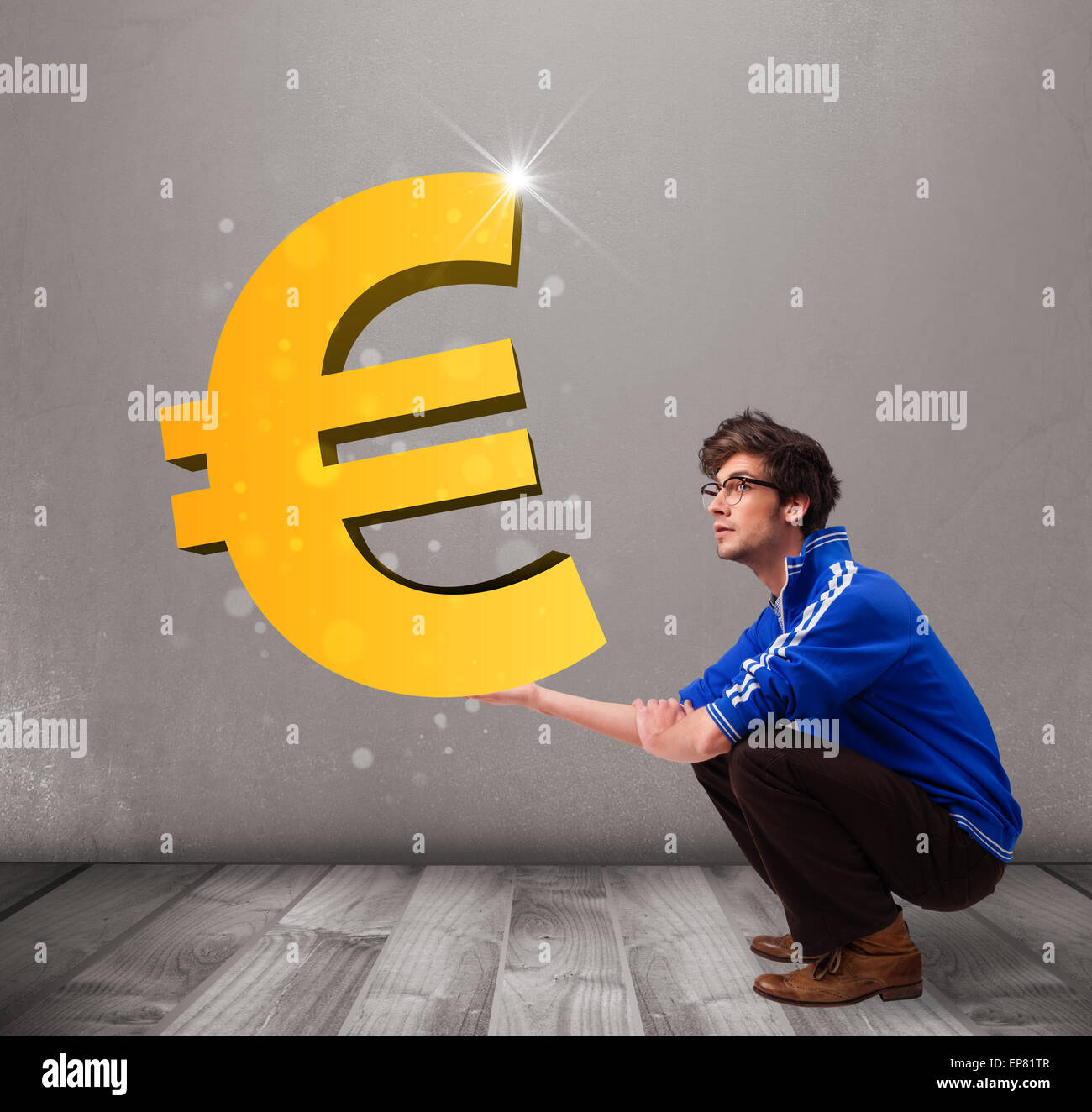 Good-looking boy holding a big 3d gold euro sign Stock Photo - Alamy