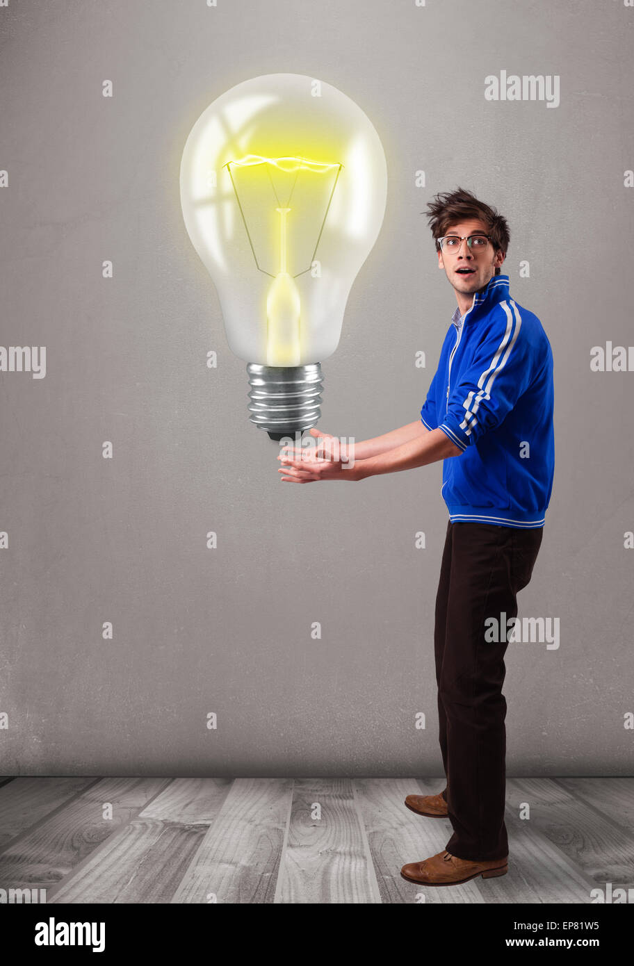 Attractive man holding realistic 3d light bulb Stock Photo - Alamy