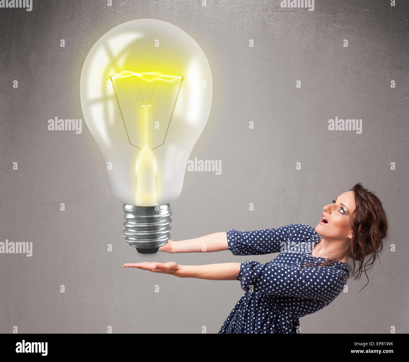Beautiful lady holding realistic 3d light bulb Stock Photo - Alamy