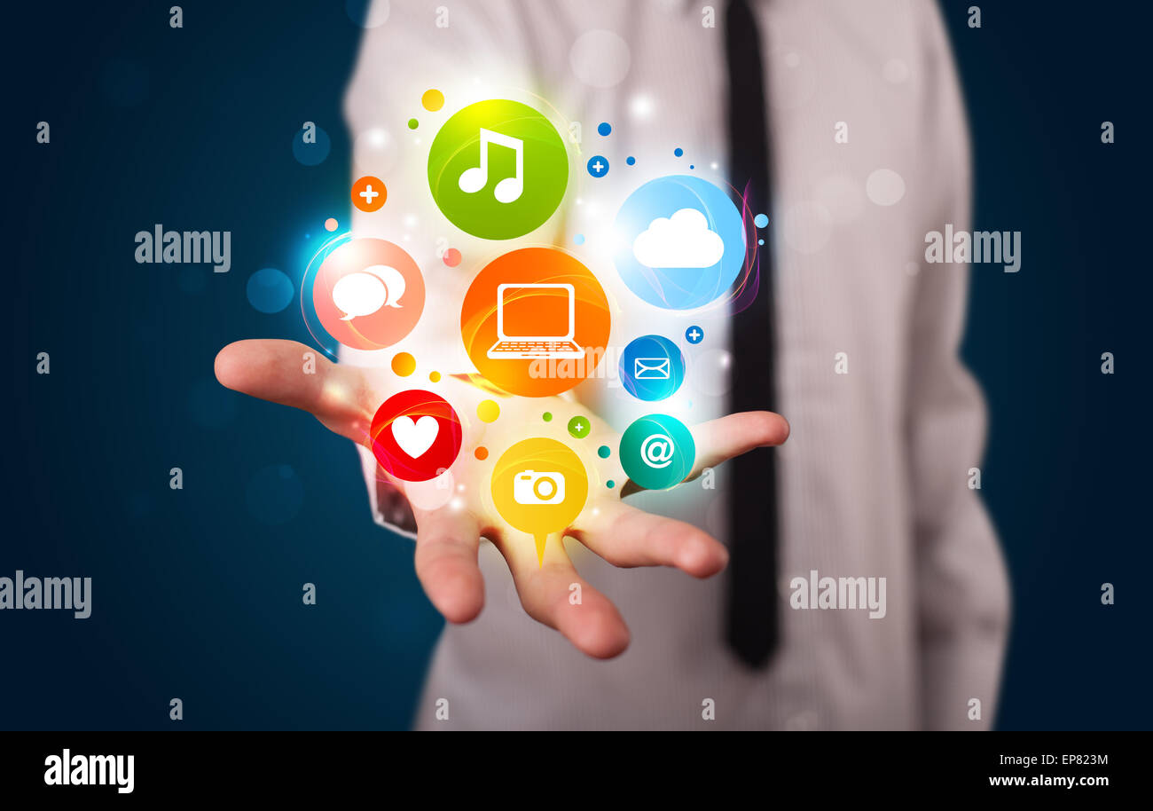 Young businessman presenting colorful technology icons and symbols ...