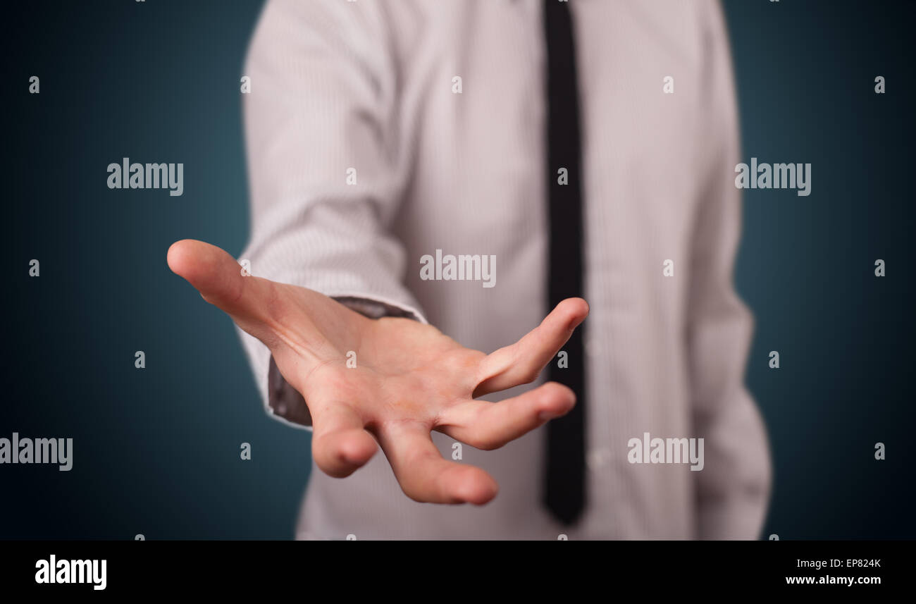 Handsome business man presenting with hand copy space Stock Photo - Alamy