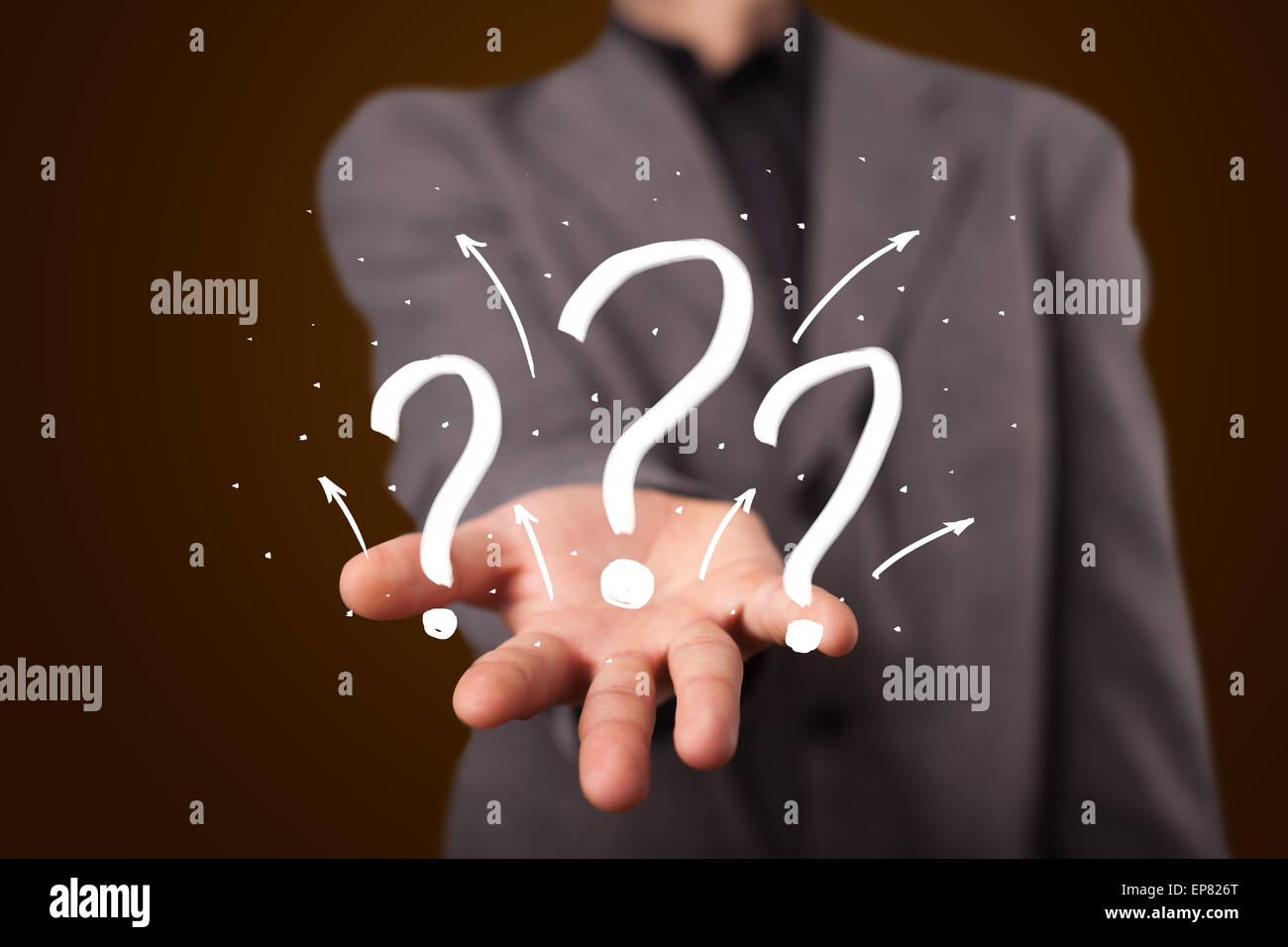 Young businessman presenting hand drawn question marks Stock Photo - Alamy
