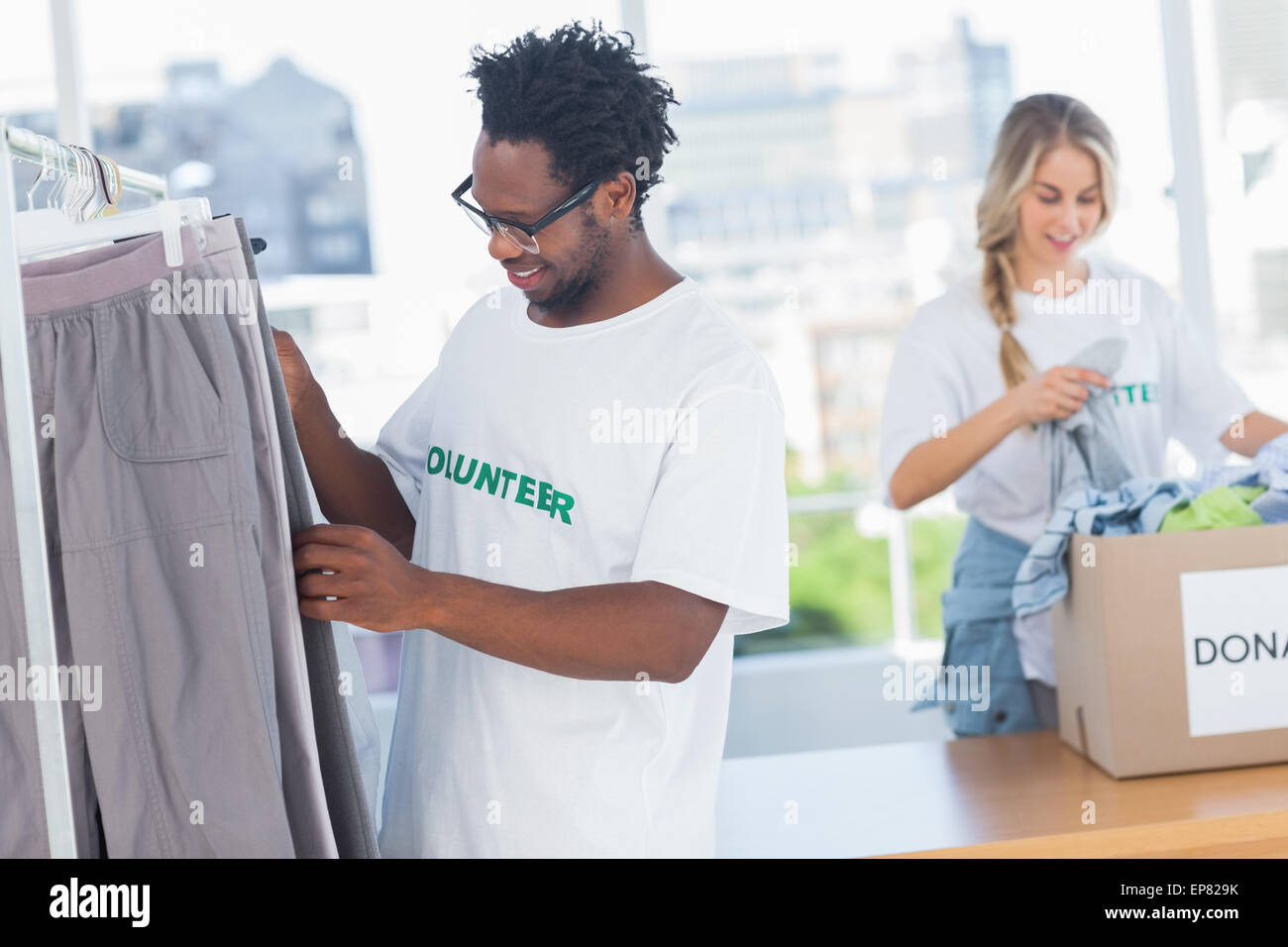Woman sorting clothes out hi-res stock photography and images - Alamy