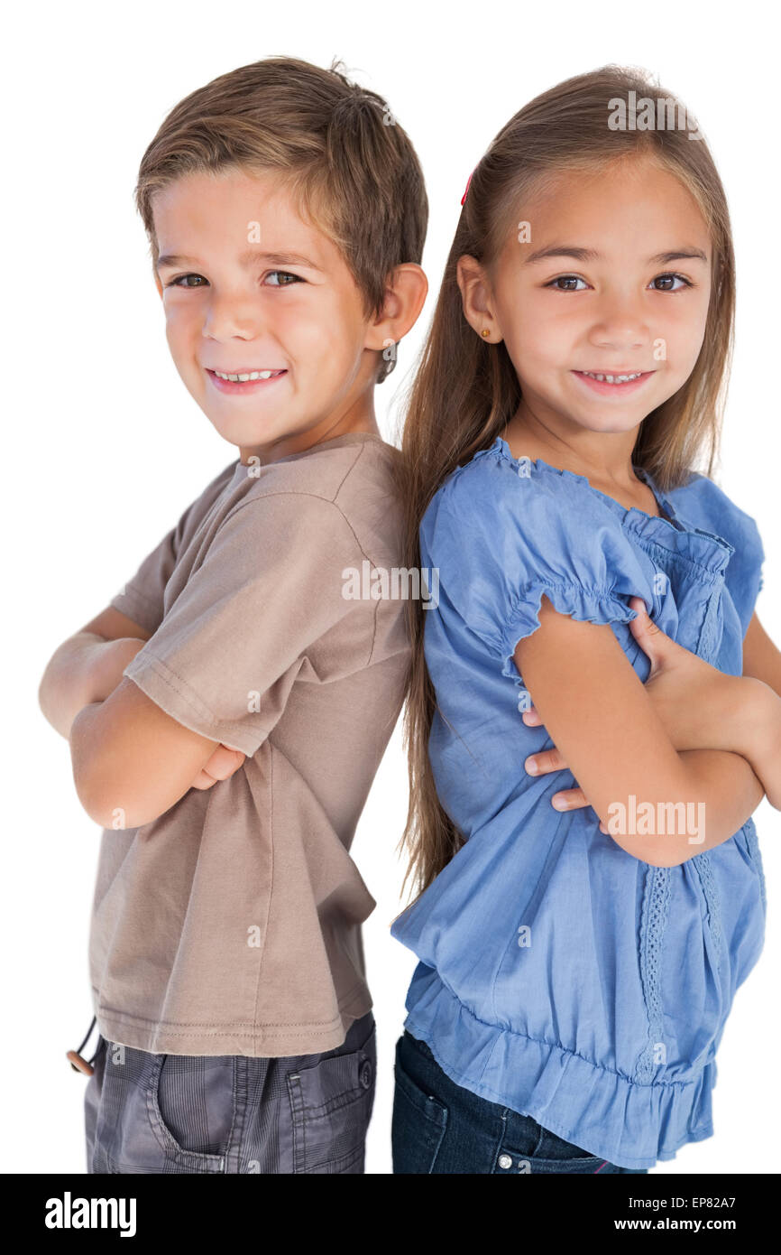 Children standing back to back with their arms crossed Stock Photo - Alamy