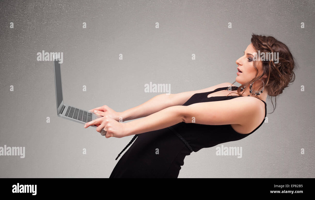 Young woman holding modern laptot Stock Photo - Alamy