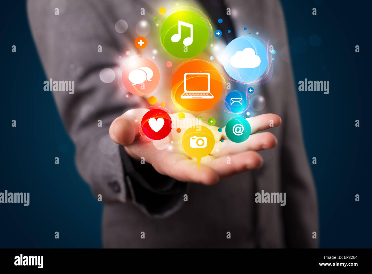 Young businessman presenting colorful technology icons and symbols ...