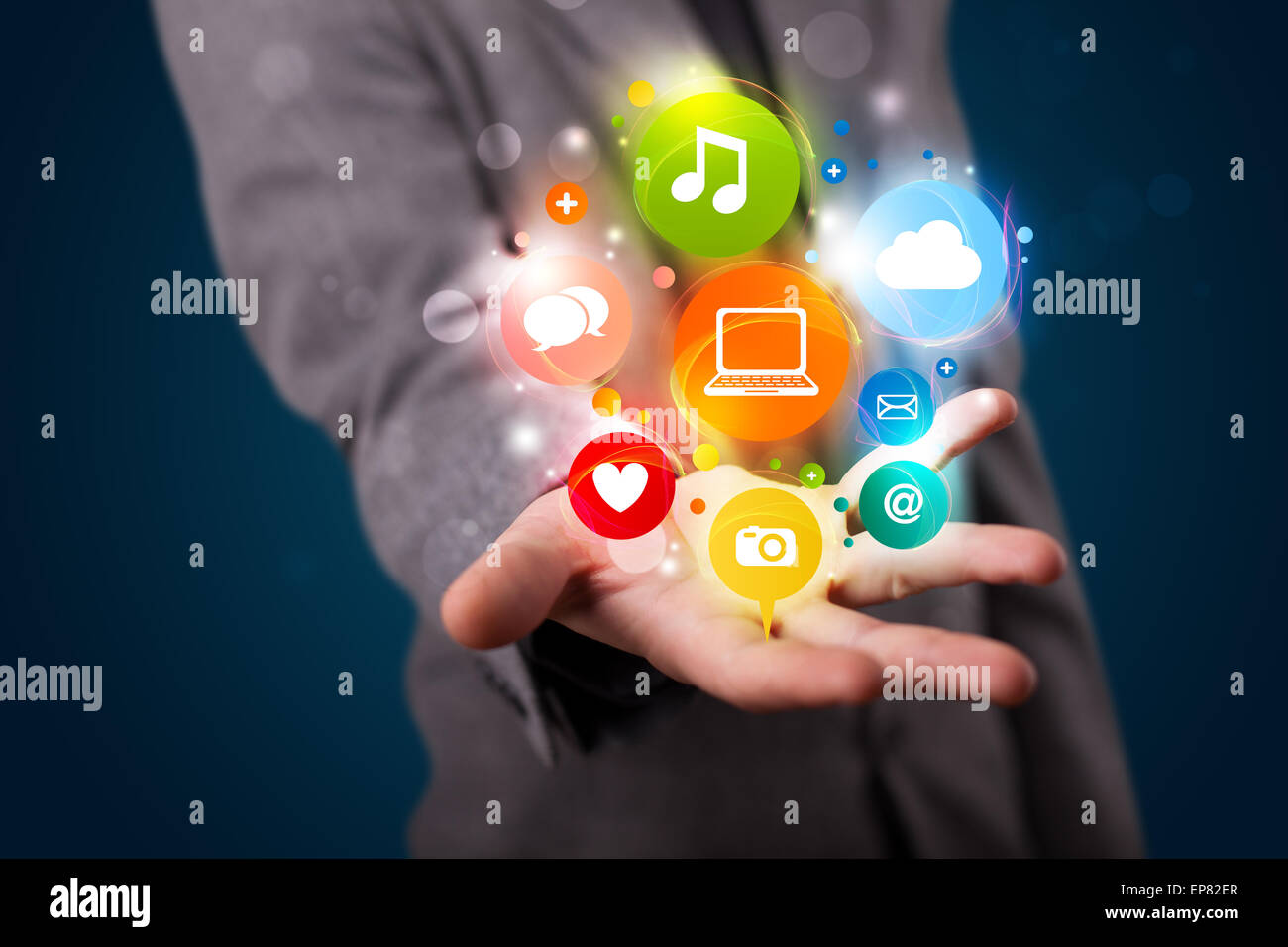 Young businessman presenting colorful technology icons and symbols ...