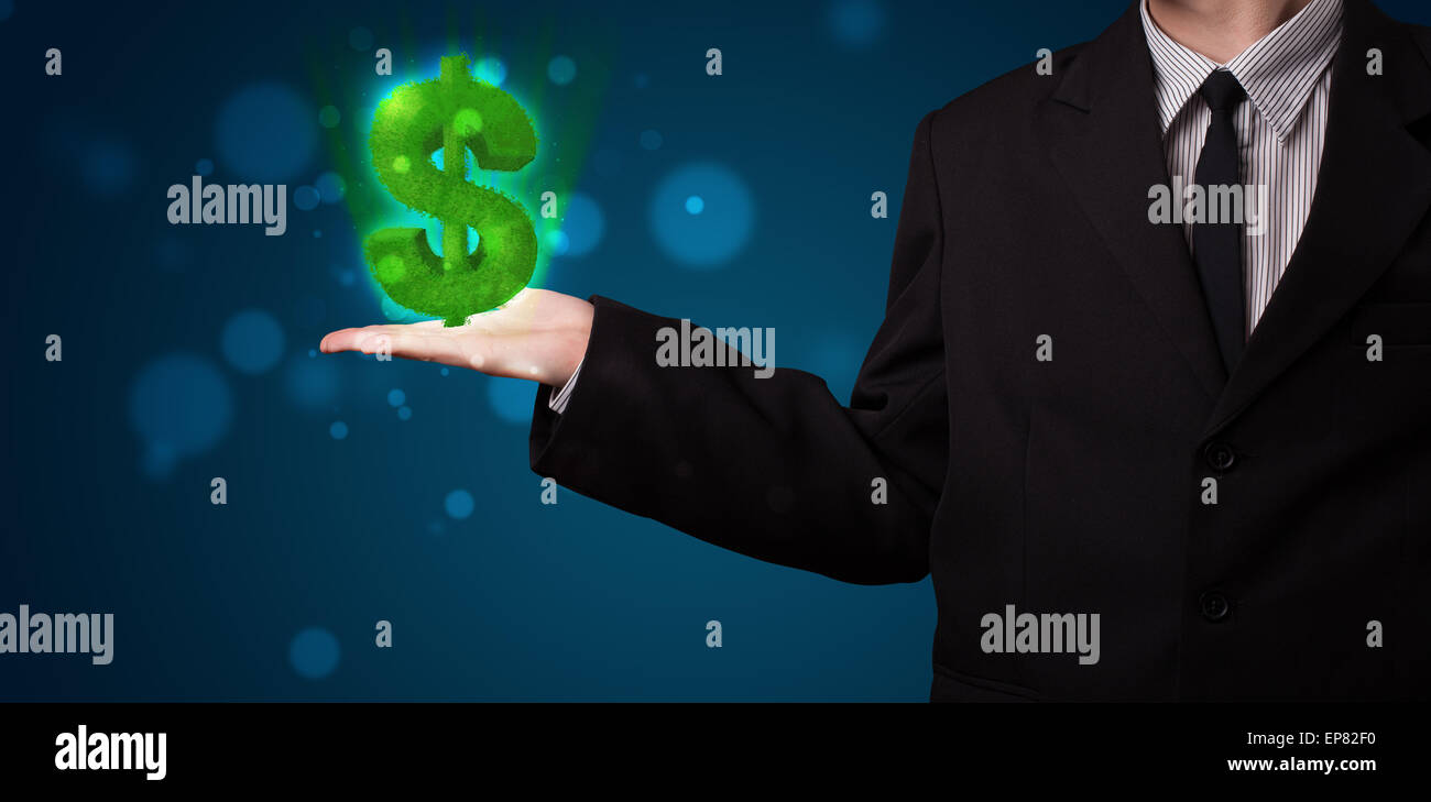Young businessman presenting green glowing dollar sign Stock Photo - Alamy Young businessman presenting green glowing dollar sign Stock Photo - Alamy