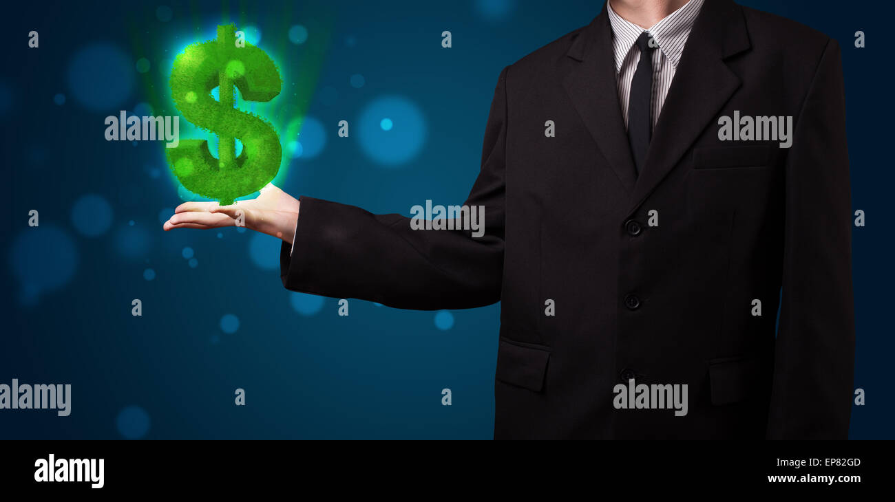 Young businessman presenting green glowing dollar sign Stock Photo - Alamy Young businessman presenting green glowing dollar sign Stock Photo - Alamy