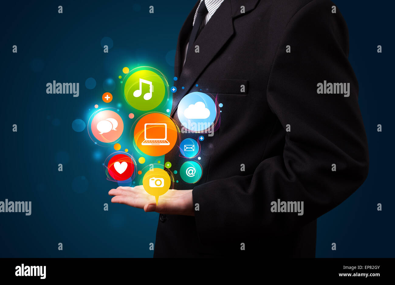 Young businessman presenting colorful technology icons and symbols ...