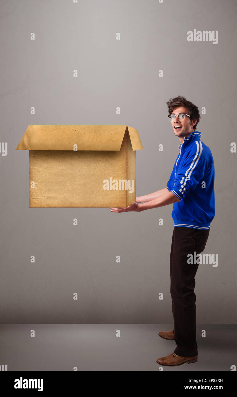 Goog-looking man holding an empty brown cardboard box Stock Photo - Alamy