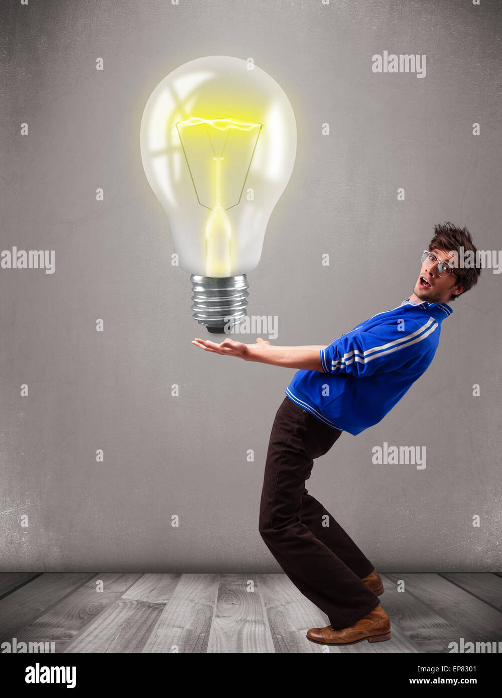 Attractive man holding realistic 3d light bulb Stock Photo - Alamy