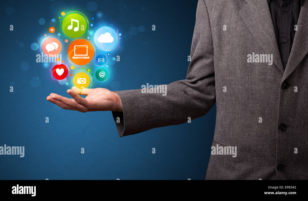 Multimedia icons in the hand of a businessman Stock Photo - Alamy
