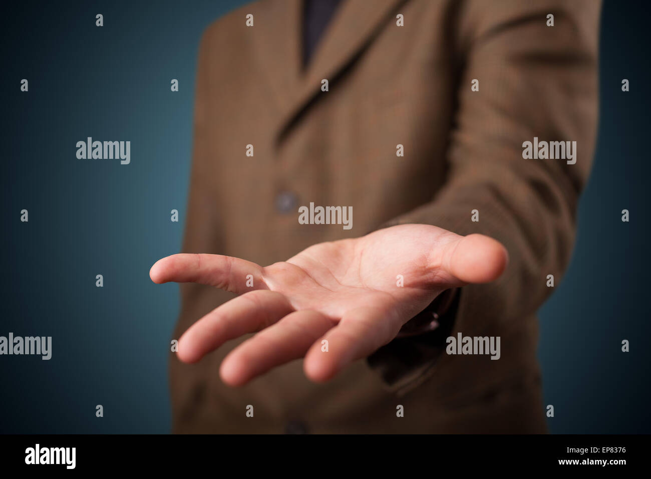 Handsome business man presenting with hand copy space Stock Photo - Alamy