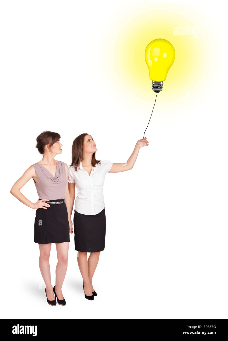 Happy women holding a light bulb balloon Stock Photo - Alamy