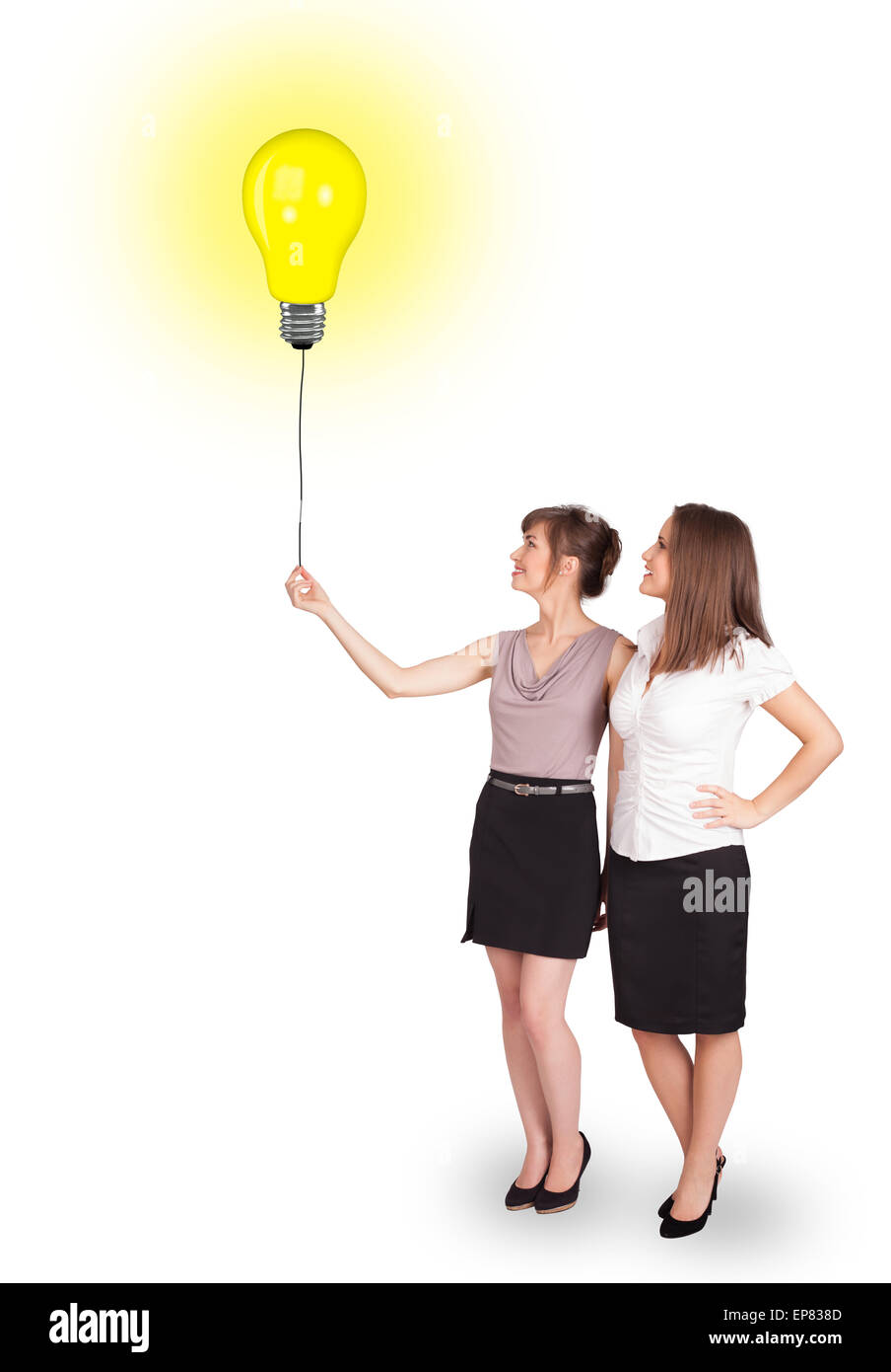 Happy women holding a light bulb balloon Stock Photo - Alamy
