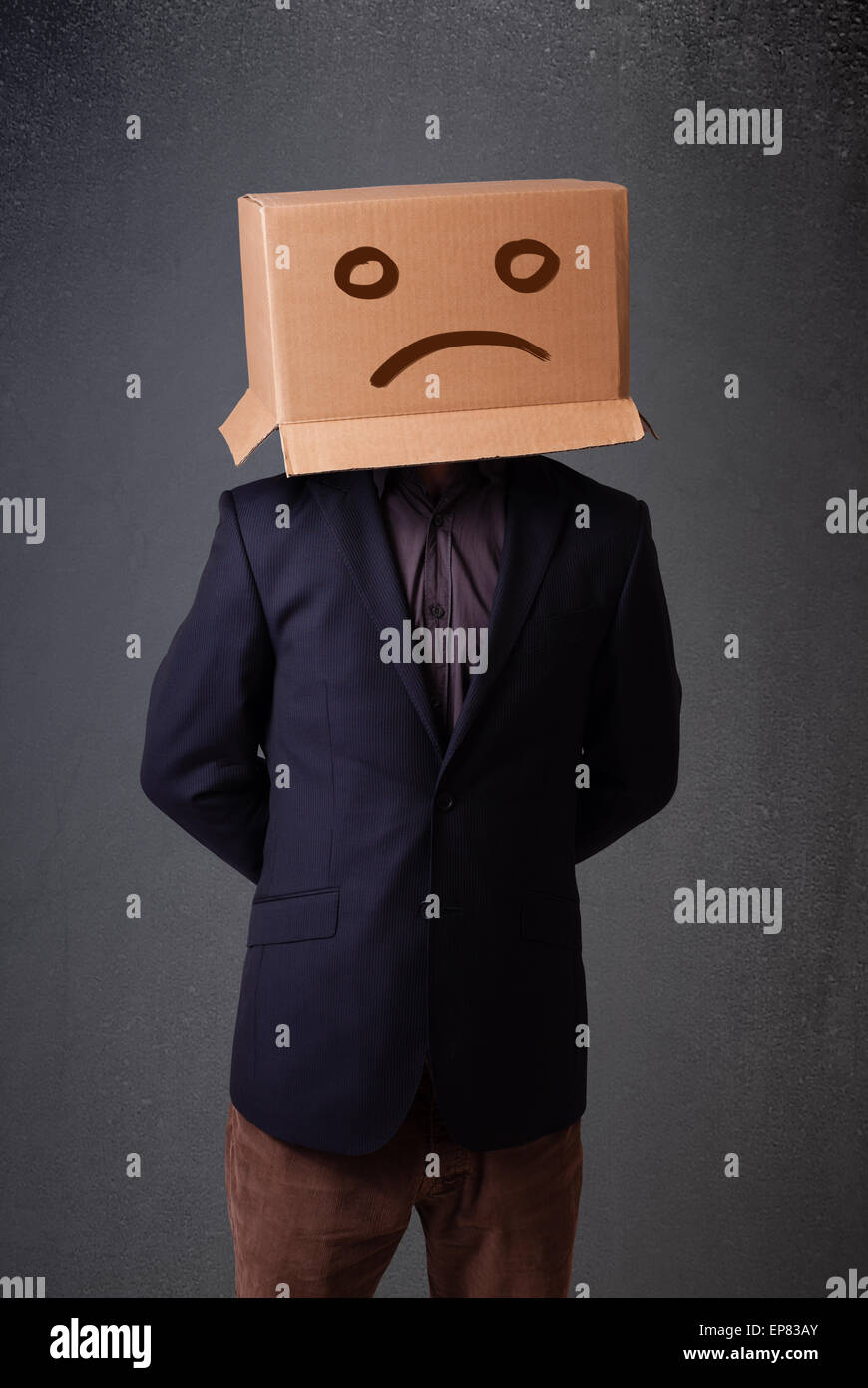 Young man with a brown cardboard box on his head with sad face Stock ...