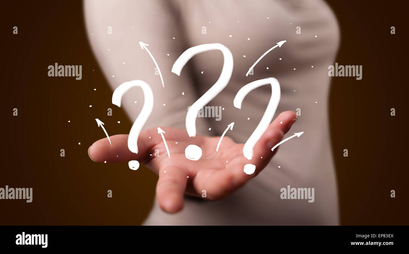 Young woman presenting hand drawn question marks Stock Photo - Alamy