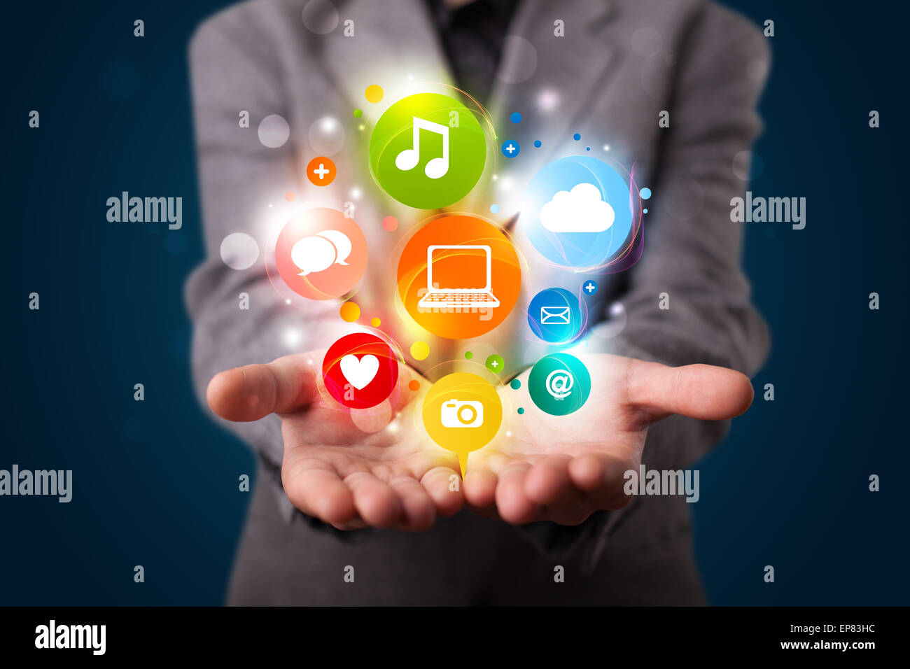 Young businessman presenting colorful technology icons and symbols ...