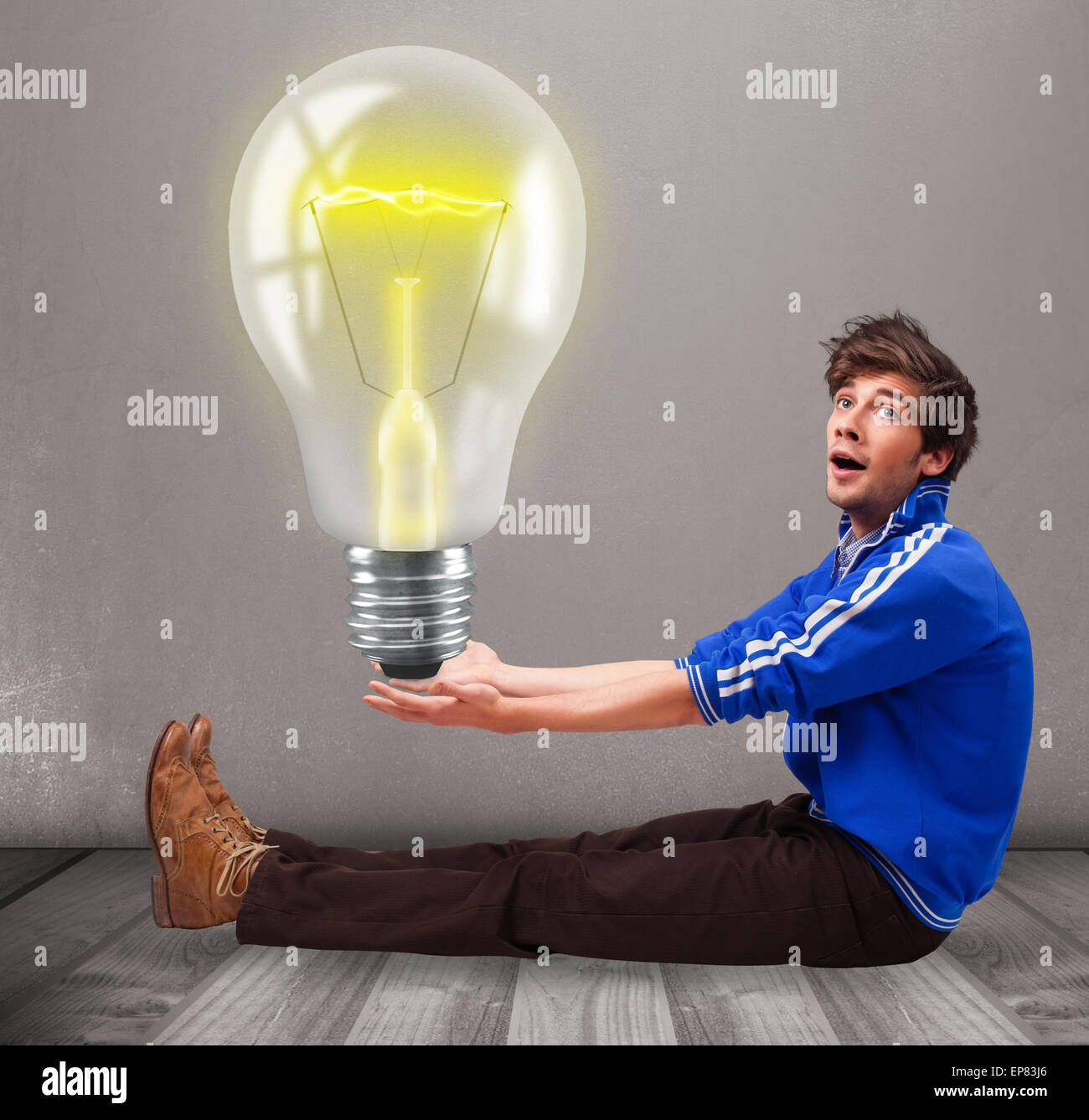 Attractive man holding realistic 3d light bulb Stock Photo - Alamy