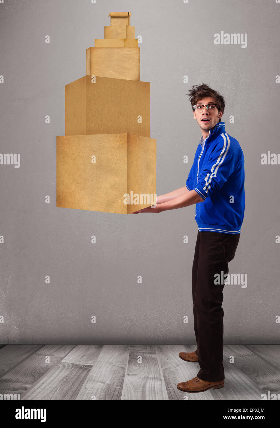 Young man holding a set of brown cardboard boxes Stock Photo - Alamy