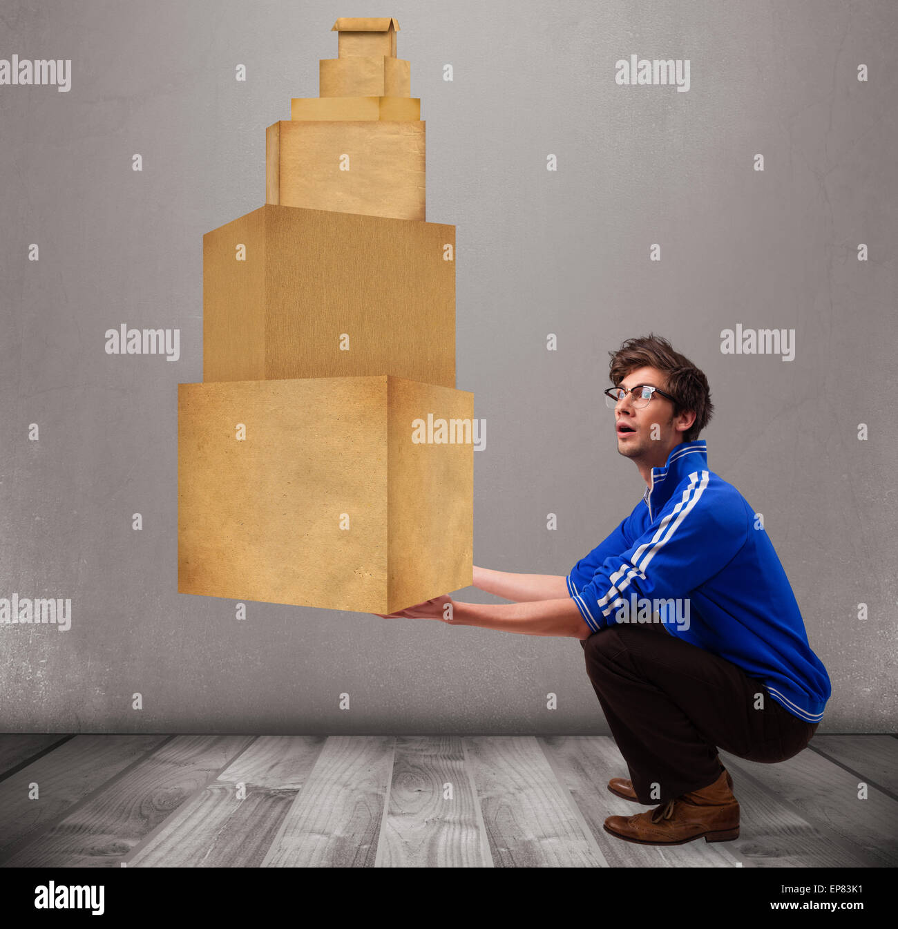 Young man holding a set of brown cardboard boxes Stock Photo - Alamy